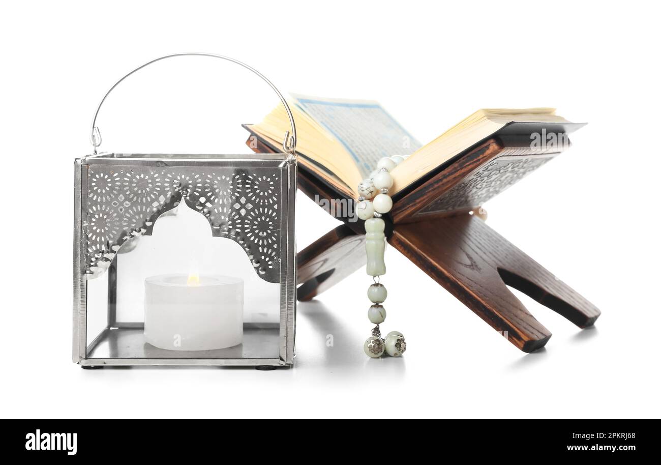 Muslim lamp with burning candle and Koran on white background Stock ...