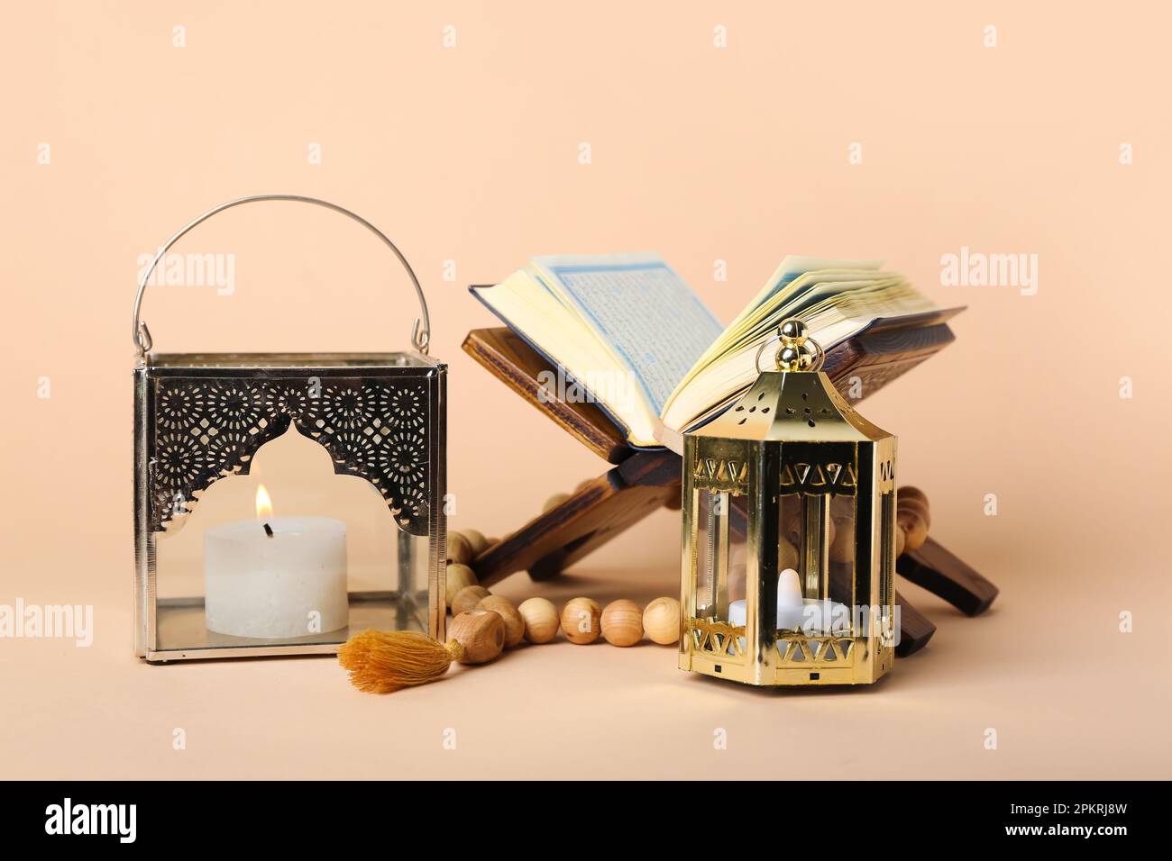 Muslim lamps with prayer beads and Koran on beige background Stock ...