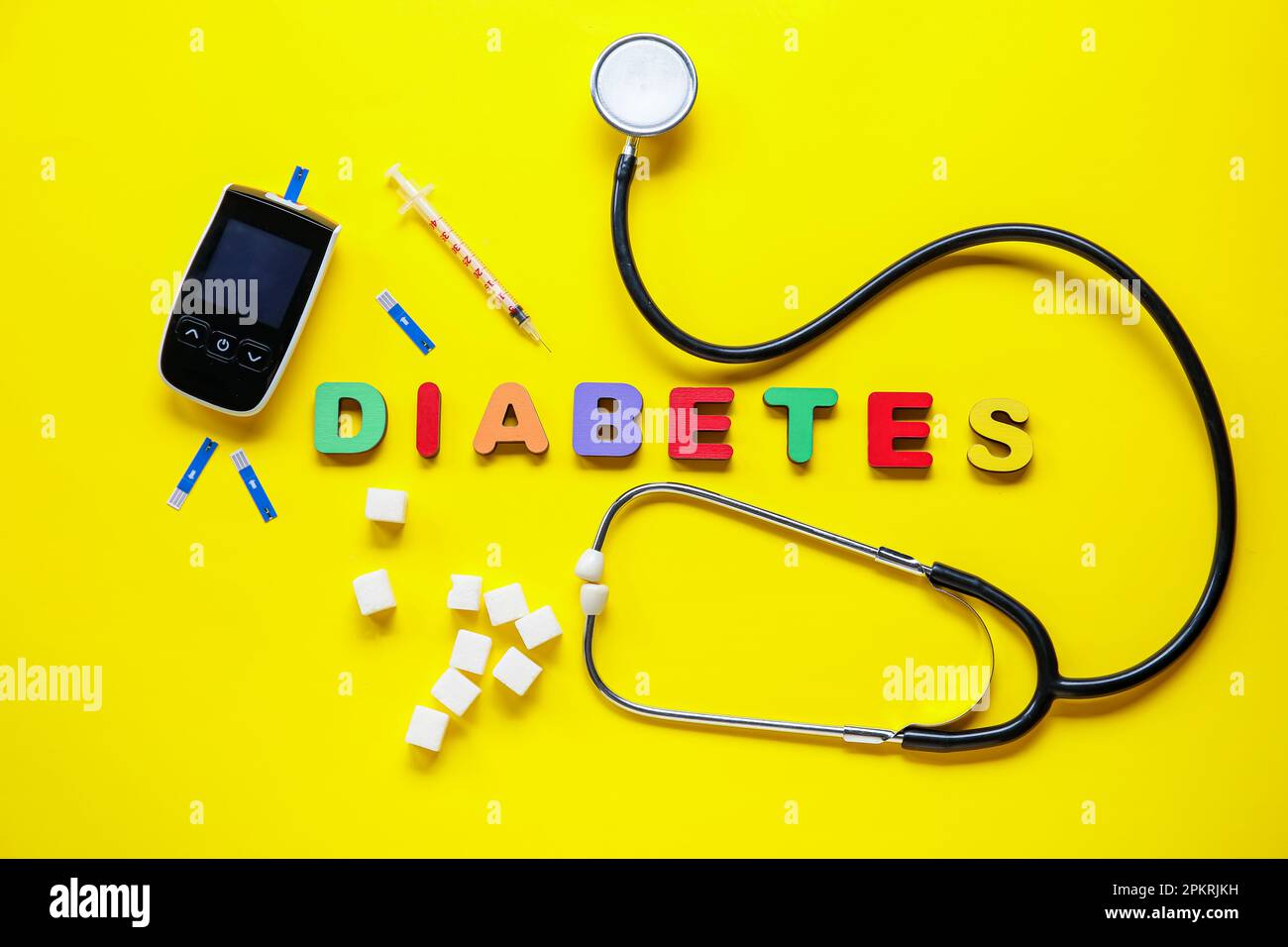 Word DIABETES with sugar, glucometer and syringe on yellow background ...