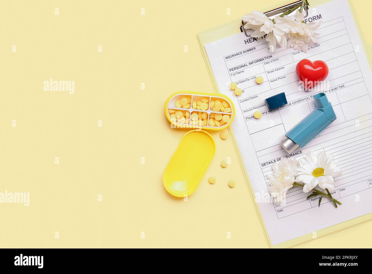 Asthma inhaler with test result, heart, flowers and pills on yellow ...