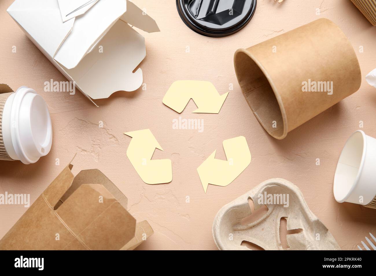 Recycling sign with garbage on beige background Stock Photo - Alamy