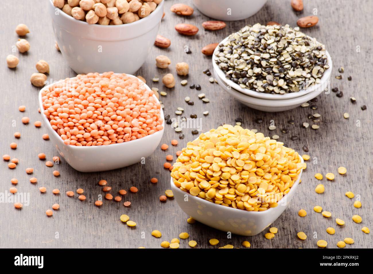 Raw chana dal with red lentils and black split gram in bowl Stock Photo ...