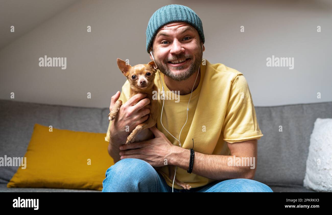 Portrait hippy snd smiling msn and his little dog Stock Photo - Alamy