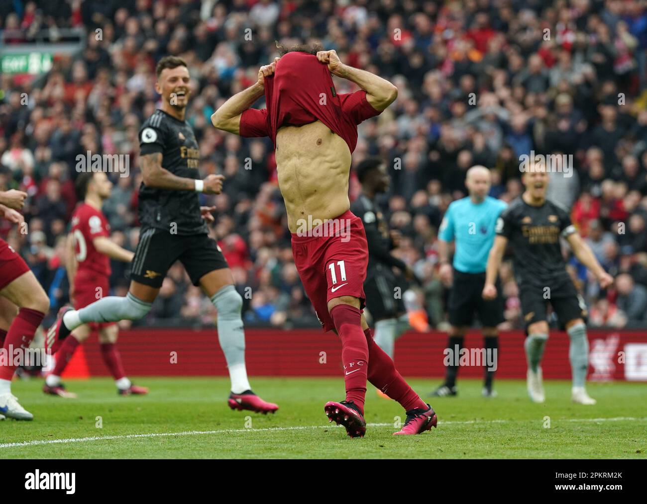 Liverpool's Mohamed Salah reacts after missing with his penalty during ...