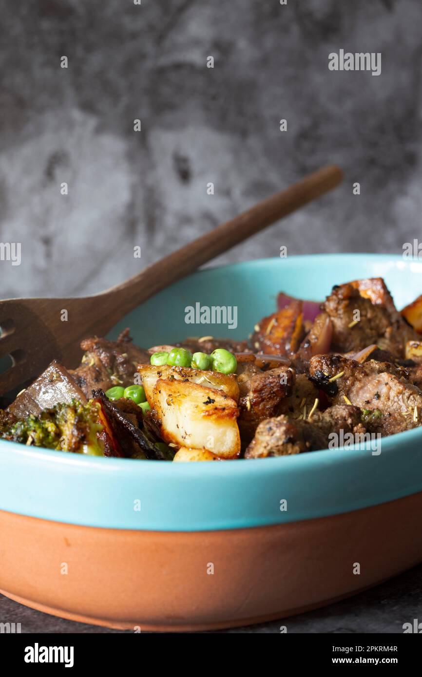 Diced lean beef steak with roast potato, broccoli, peas, onion and ...