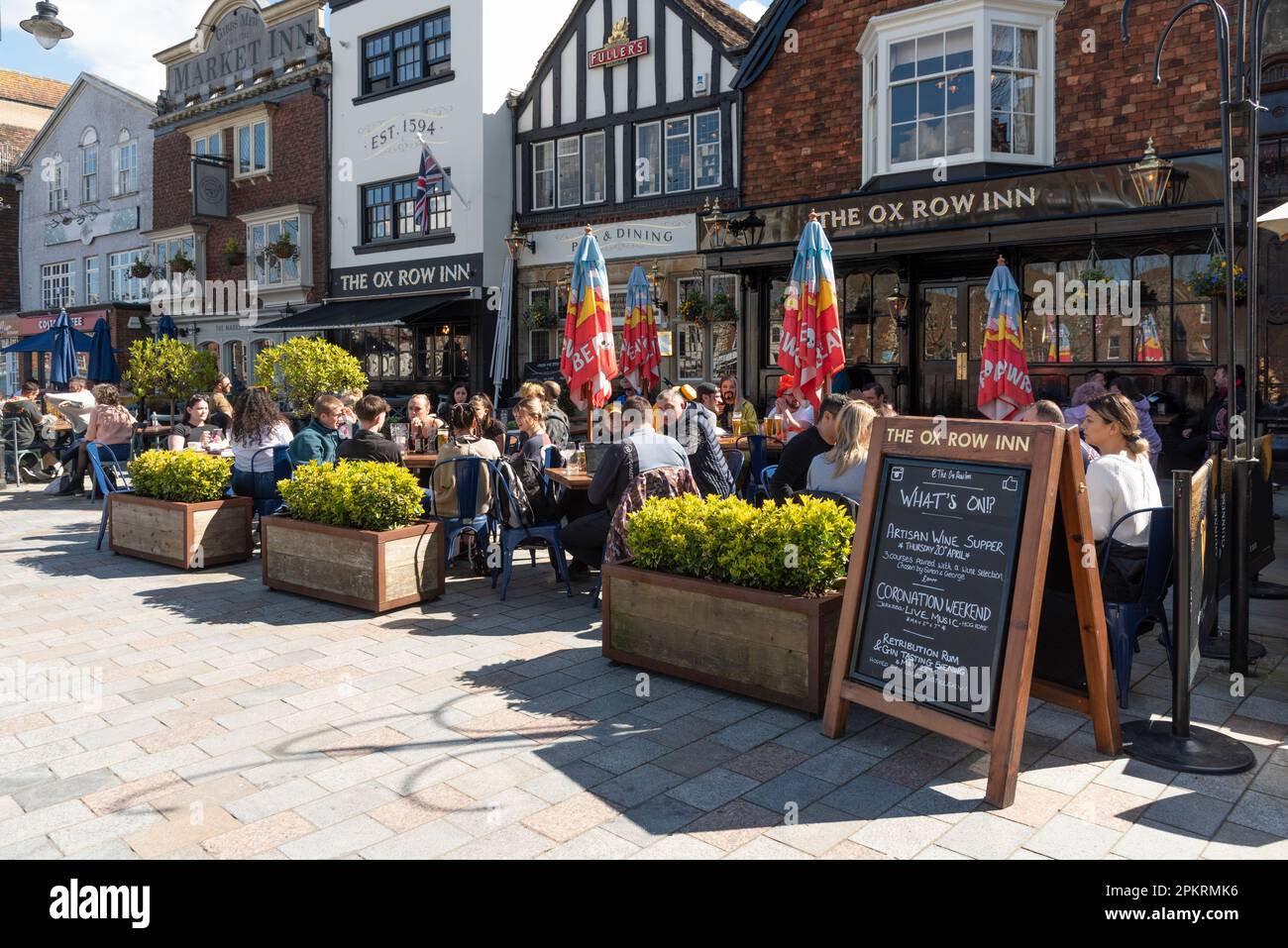 Salisbury, Wiltshire, England, UK. 2023. Customers enjoy the early Spring sunshine relaxing ...