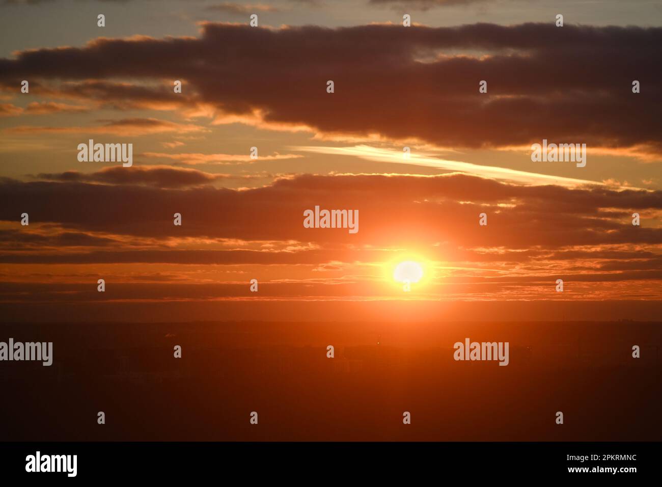 Sunset sky with red light of the setting sun. Evening clouds in the ...
