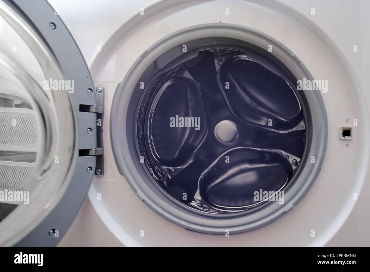 Open door of an empty home washing machine Stock Photo - Alamy