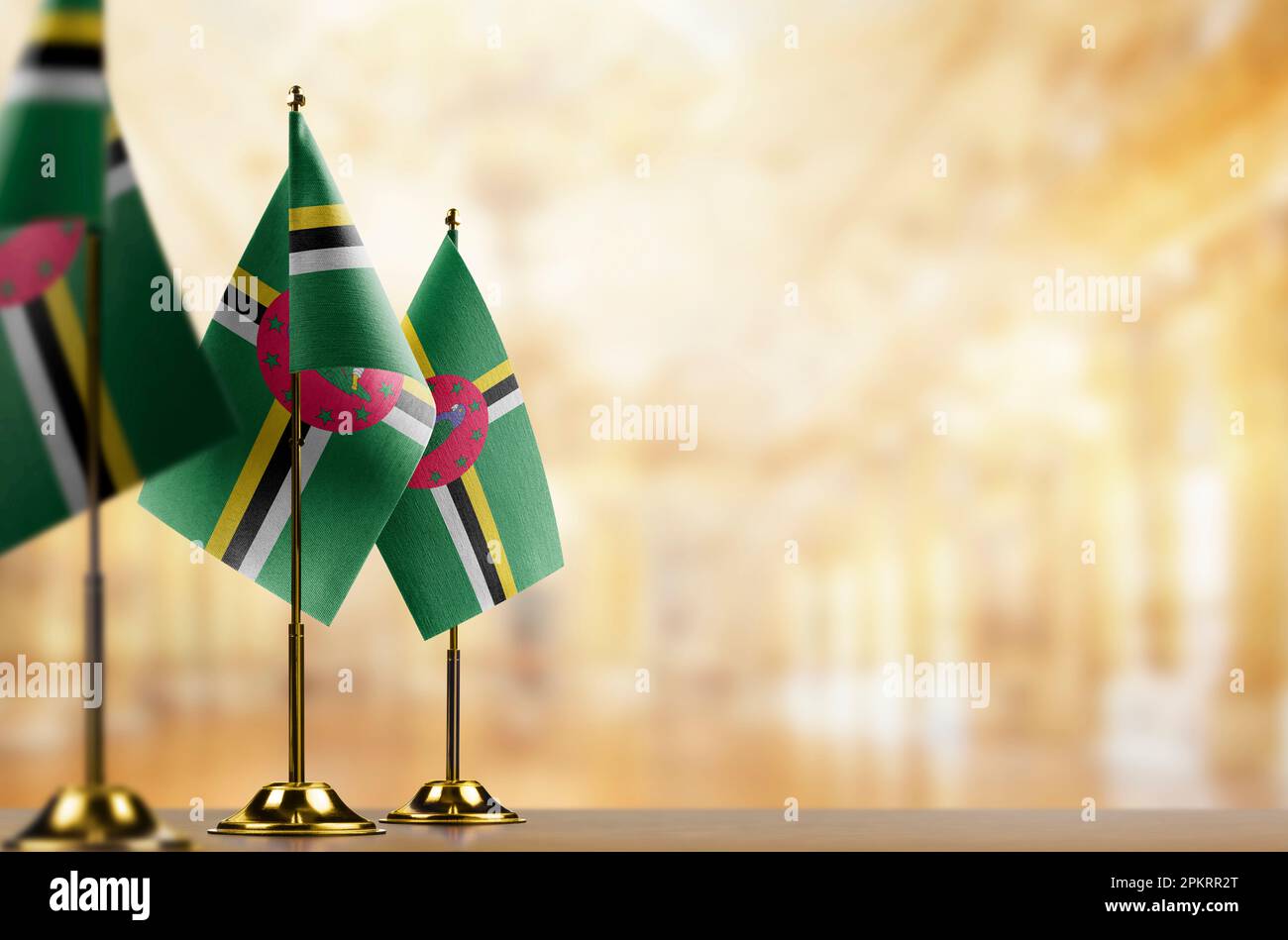 Small flags of the Dominica on an abstract blurry background Stock ...