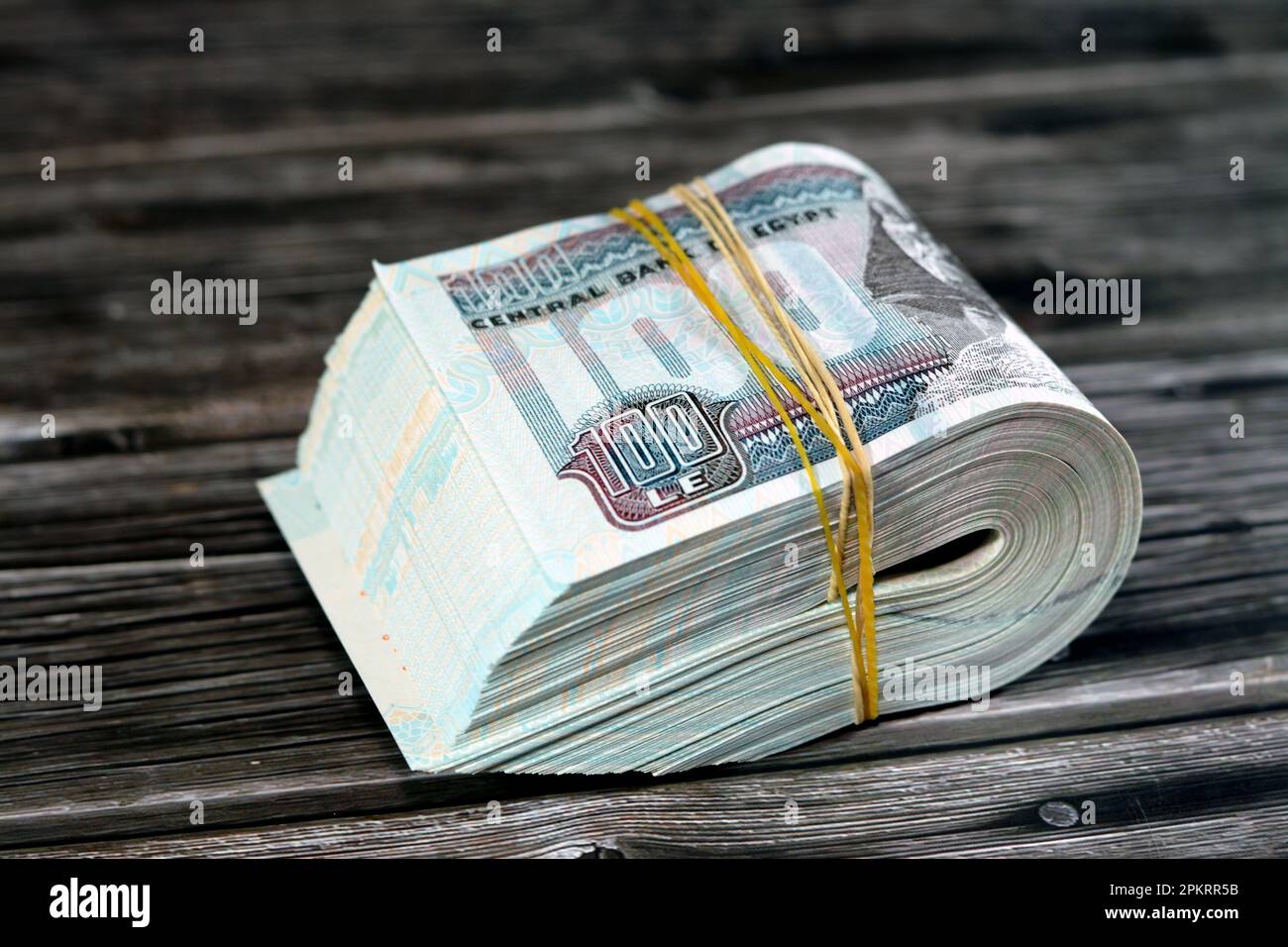 Folded 100 EGP LE one hundred Egyptian pounds cash money bills rolled ...
