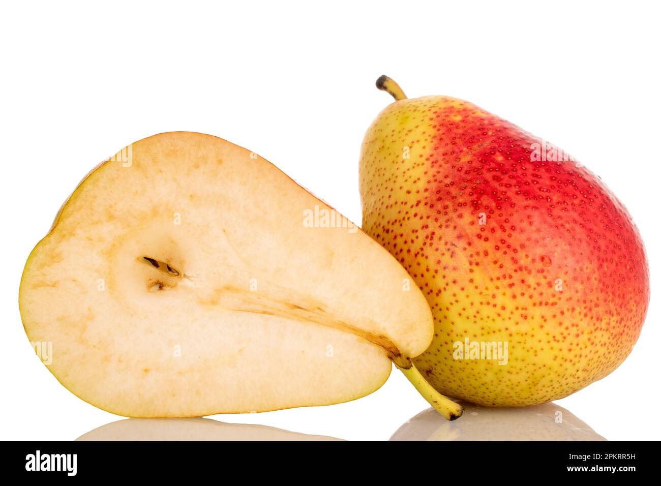 A whole pear and a slice, close-up, on a white background Stock Photo ...