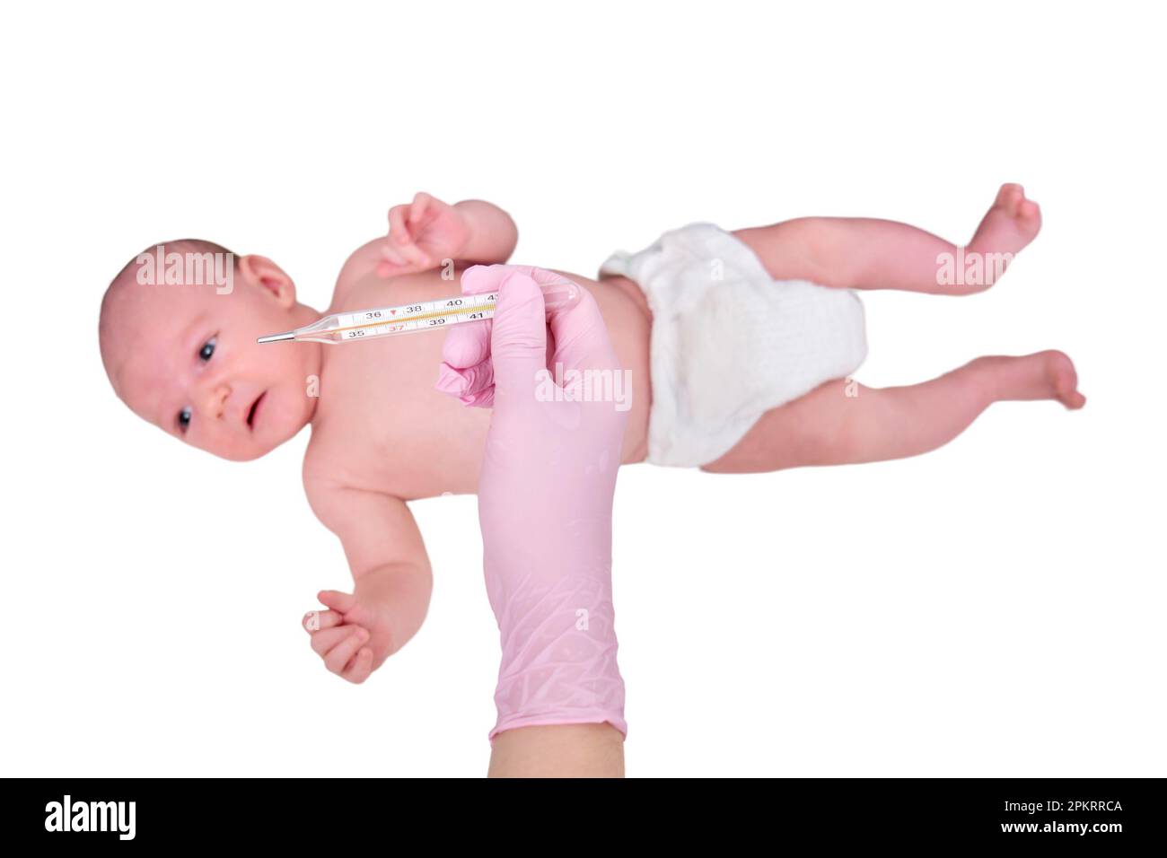Doctor checks the temperature of the newborn baby with a thermometer ...