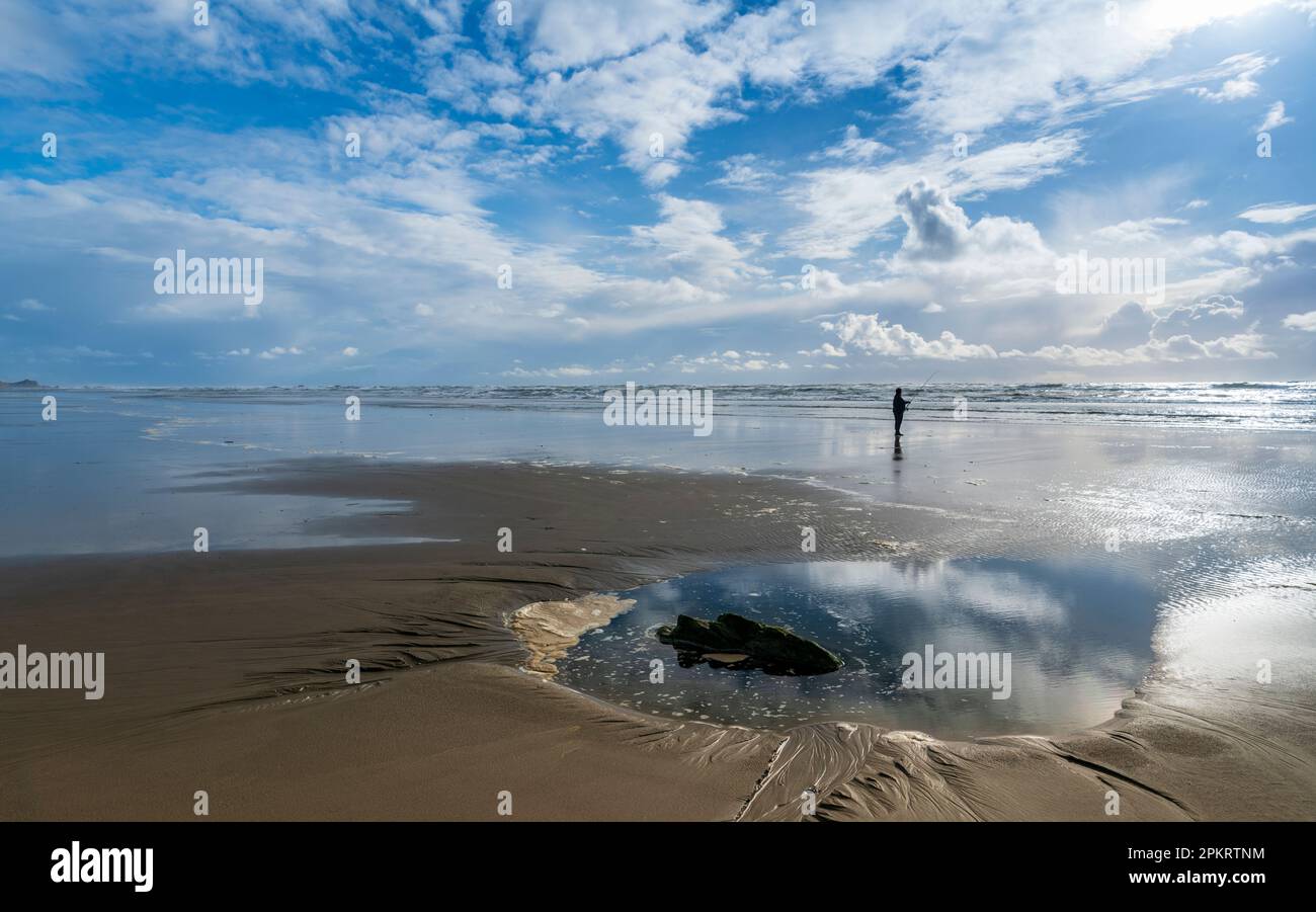 Tide pool waters reflecting vibrant skies and surrounding a lonely rock ...