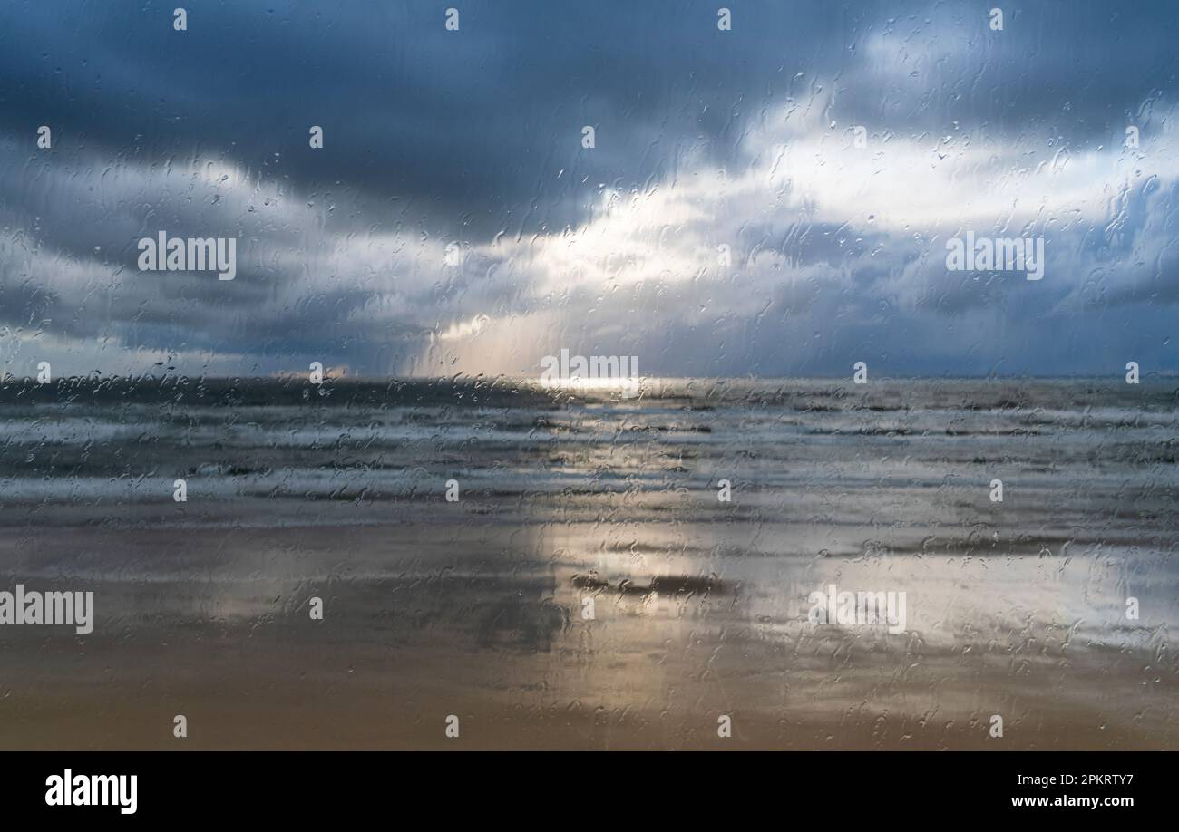 Rain drops crush at window running down the glass in stormy, windy ...