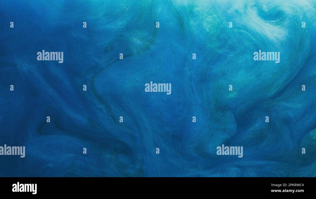 Glitter fluid ink water particles texture blue Stock Photo - Alamy