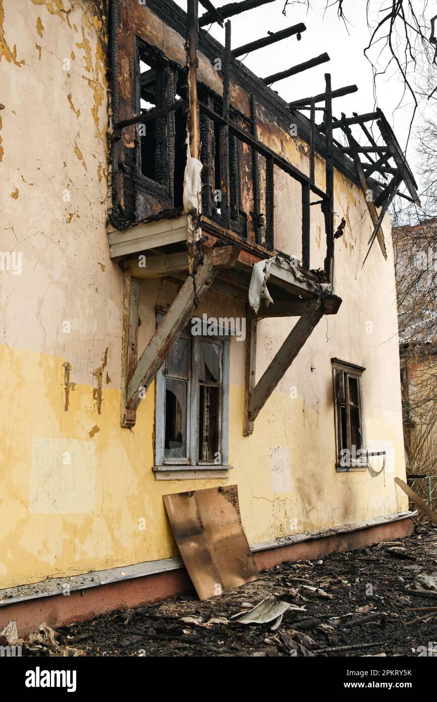 Facade of an old two-story house after a fire. Burnt residential ...