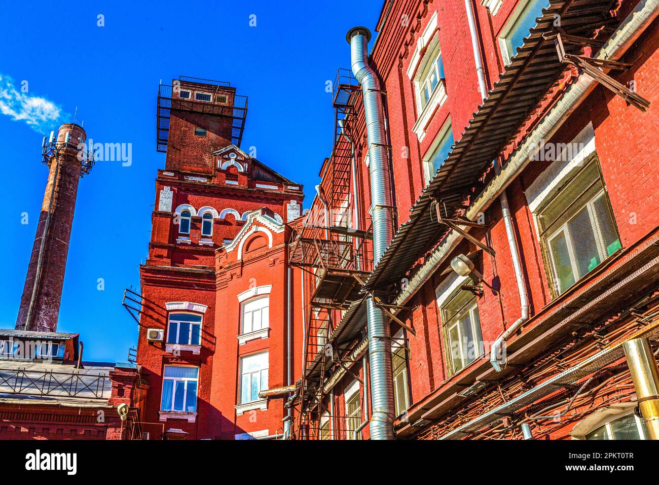 Industrial buildings and chimneys of an old red brick factory in Moscow ...
