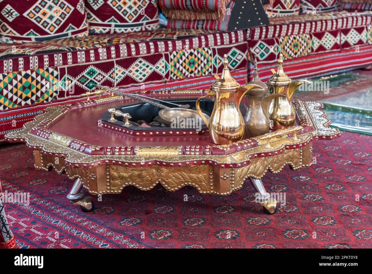 Traditional arabic coffee jugs or qahwa in Dubai with table and couch ...