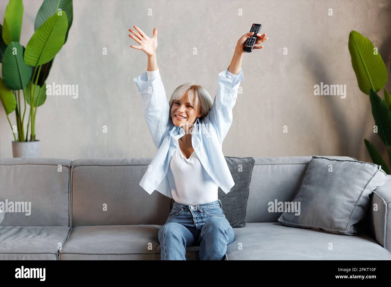 Excited girl cheering in front of television. Watching sport match on ...