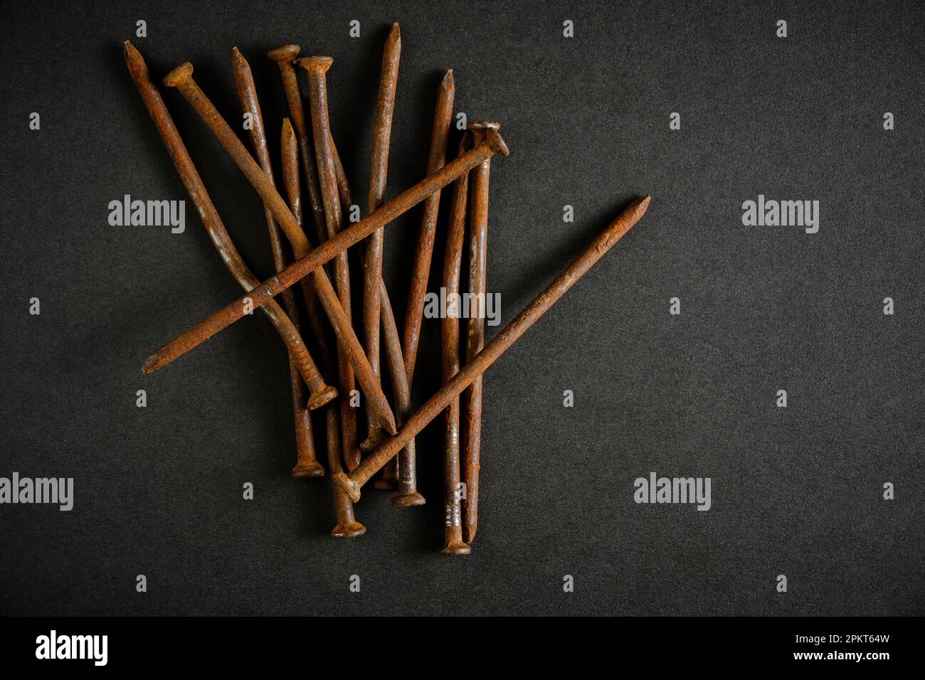 Old rusty nails on a black background Stock Photo - Alamy