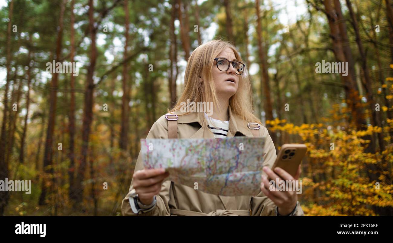 Lost traveler young woman searching direction in with a Topographic Map ...