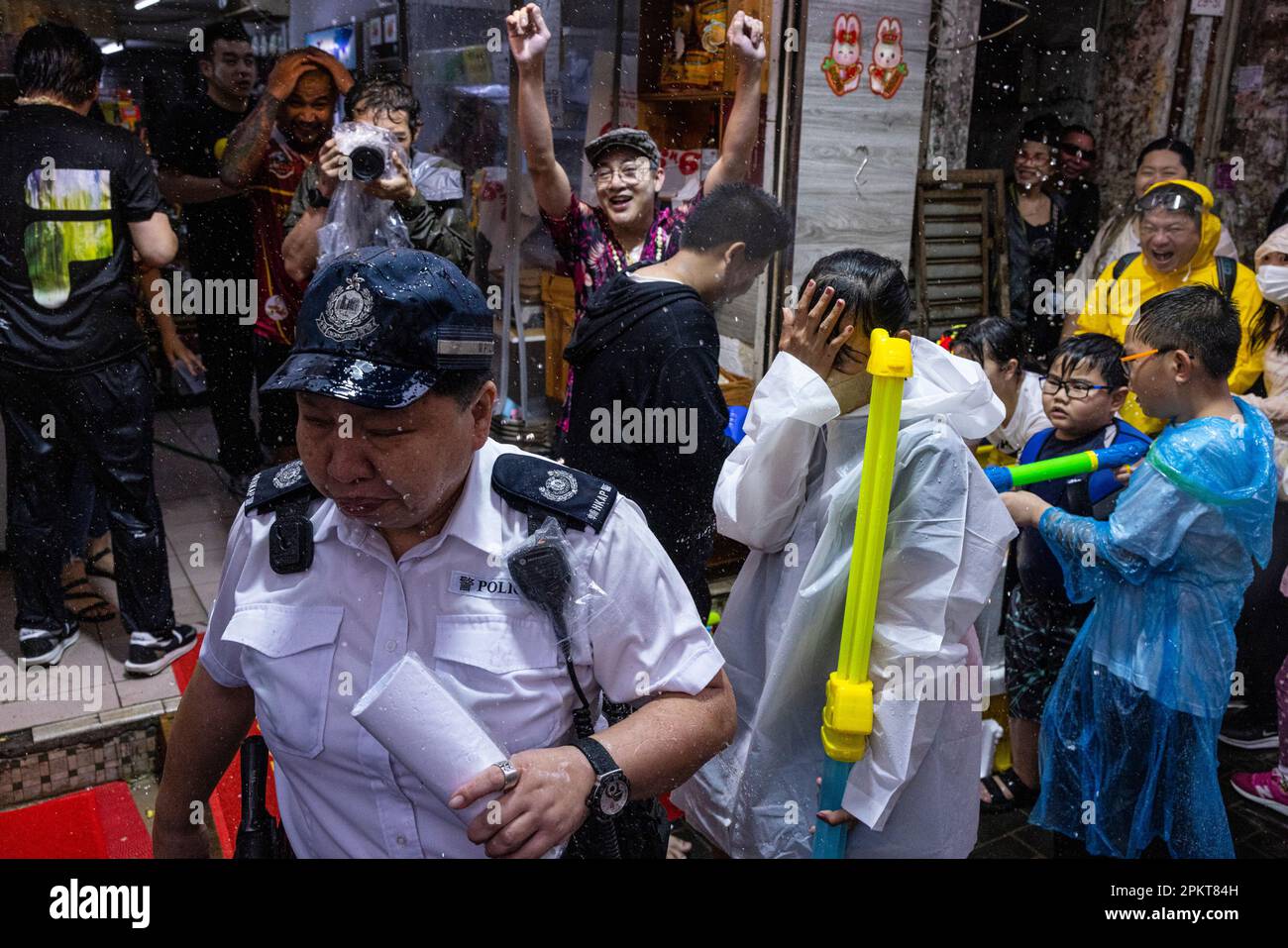 Revellers splash water on a police officer during celebrations for the ...