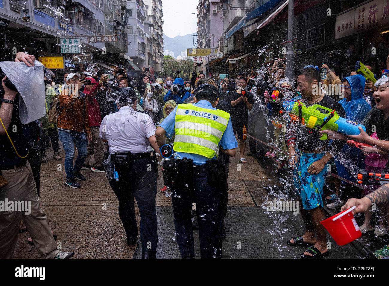 Revellers splash water on police officers during celebrations for the ...