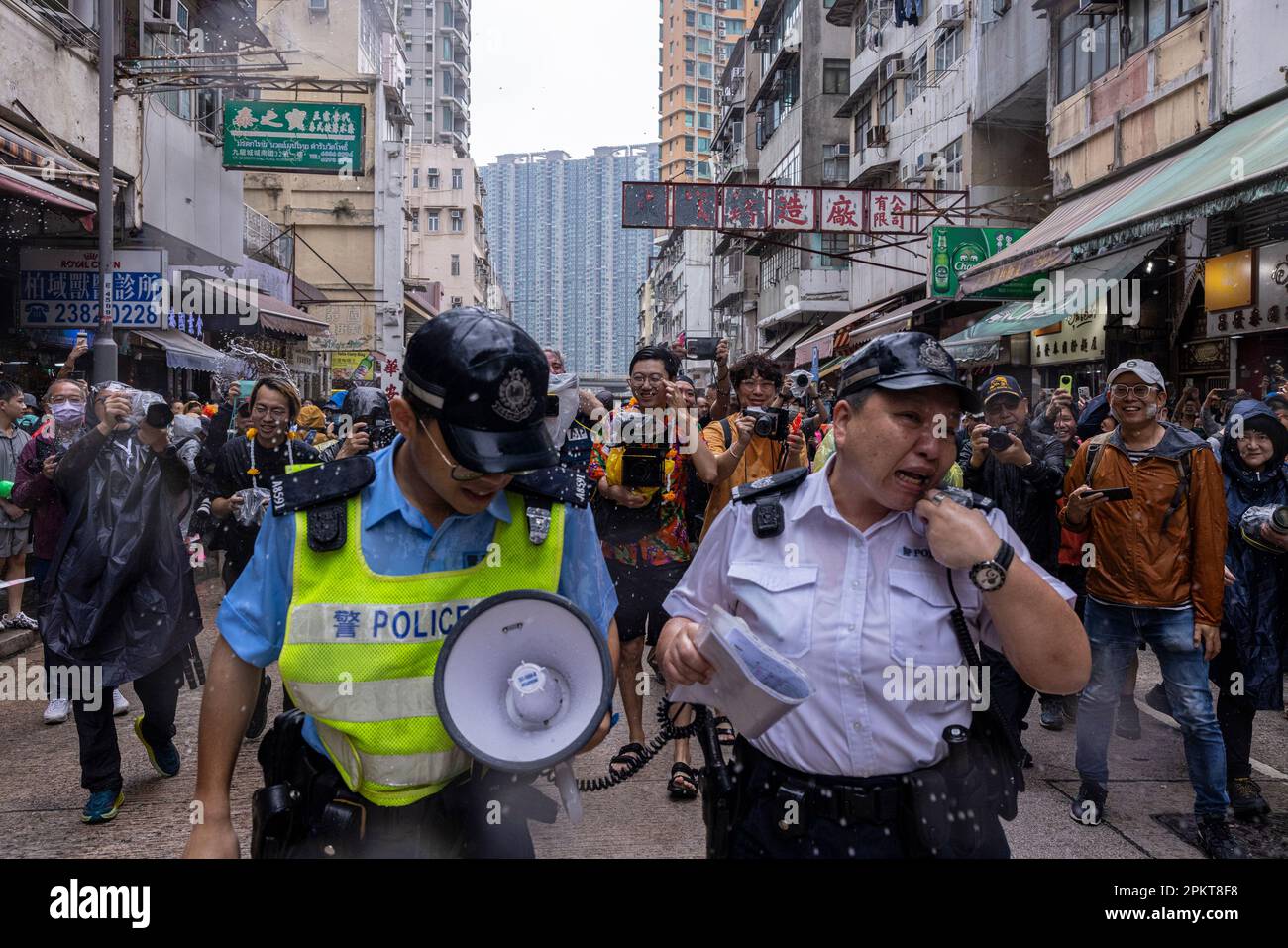 Revellers splash water on police officers during celebrations for the ...