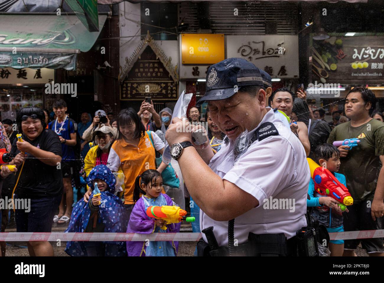 Revellers splash water on police officers during celebrations for the ...