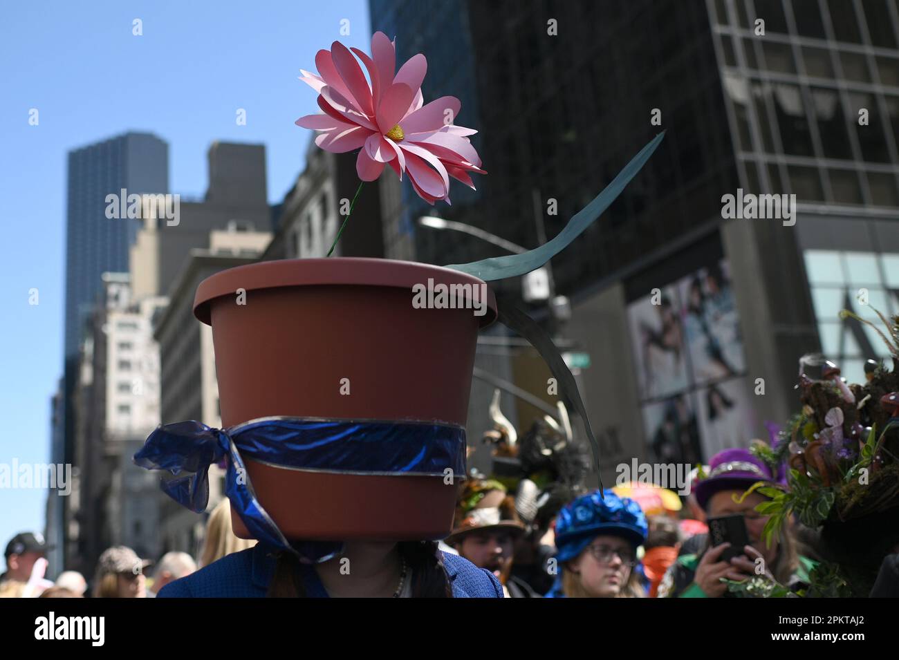 New York, USA. 09th Apr, 2023. A woman wear a large flower pot over her ...