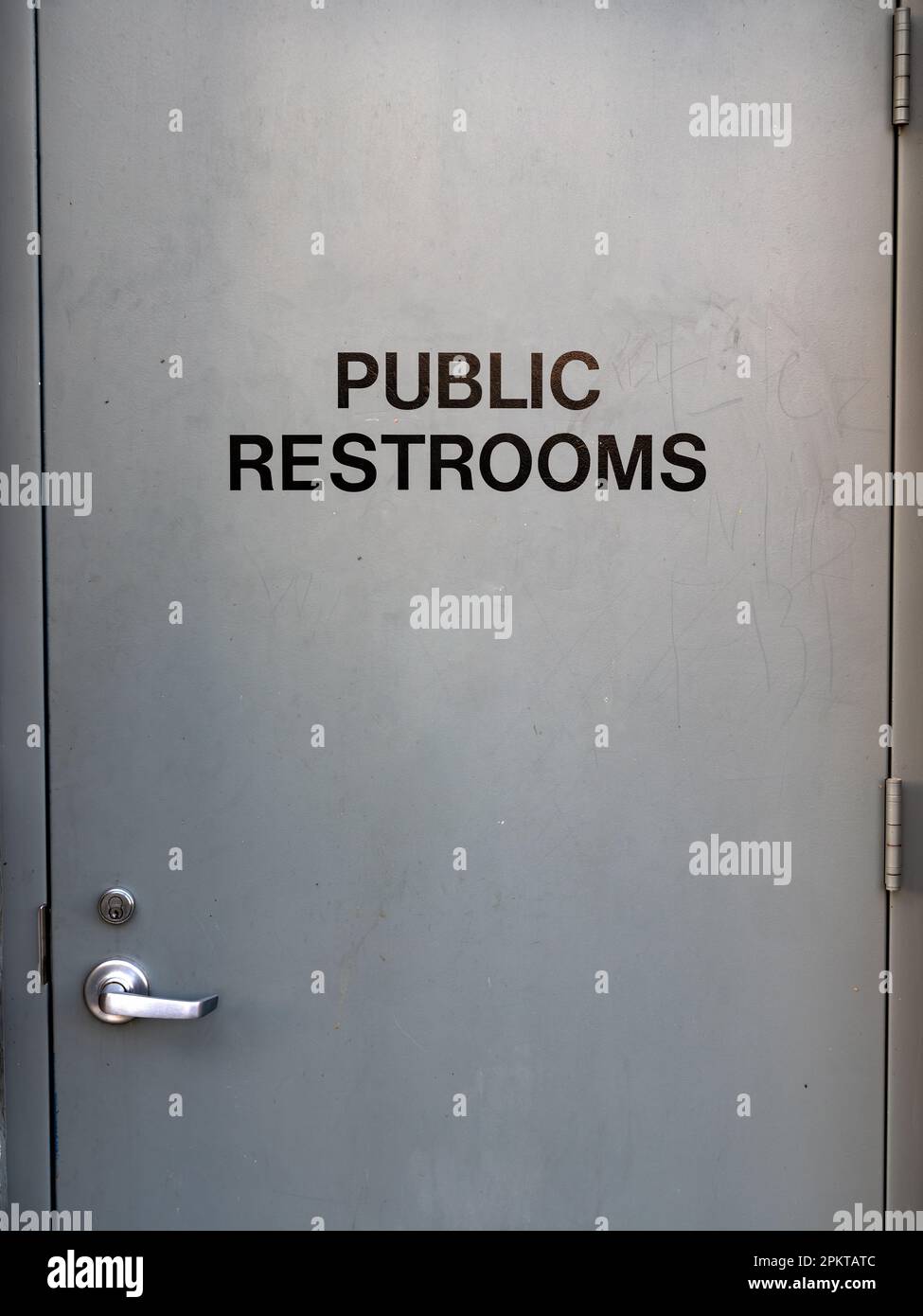 Gray door with sign Public Restroom in a park Stock Photo - Alamy