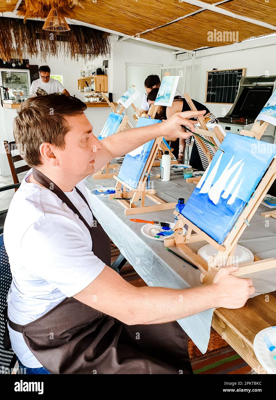 Turkey Marmaris 01.04.2023 Painting masterclass. Art party in restaurant. Glass of wine ...