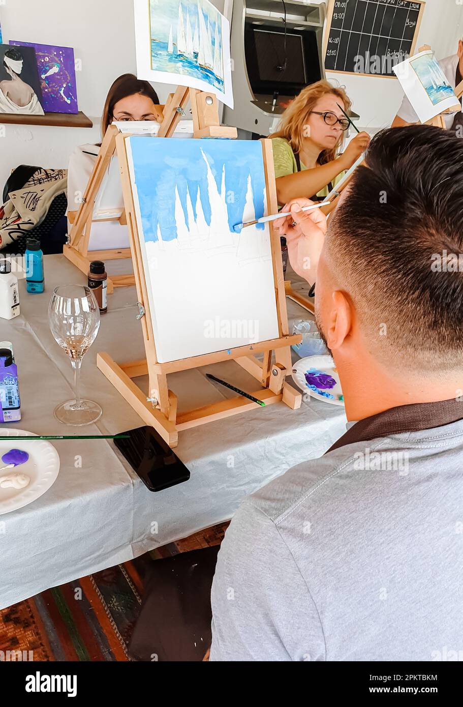 Turkey Marmaris 01.04.2023 Painting masterclass. Art party in restaurant. Glass of wine ...