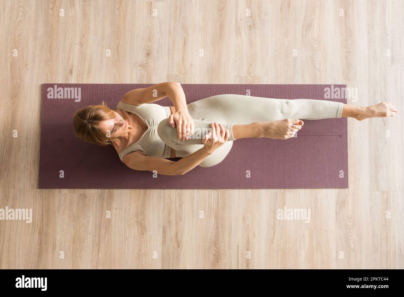 Young sporty attractive women doing pilates toning exercises for abs ...