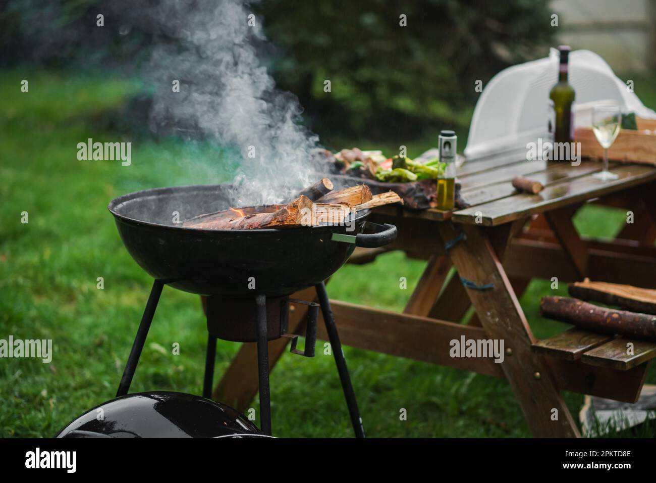 The smoking brazier of a round form. Firewood flares up in the brazier ...