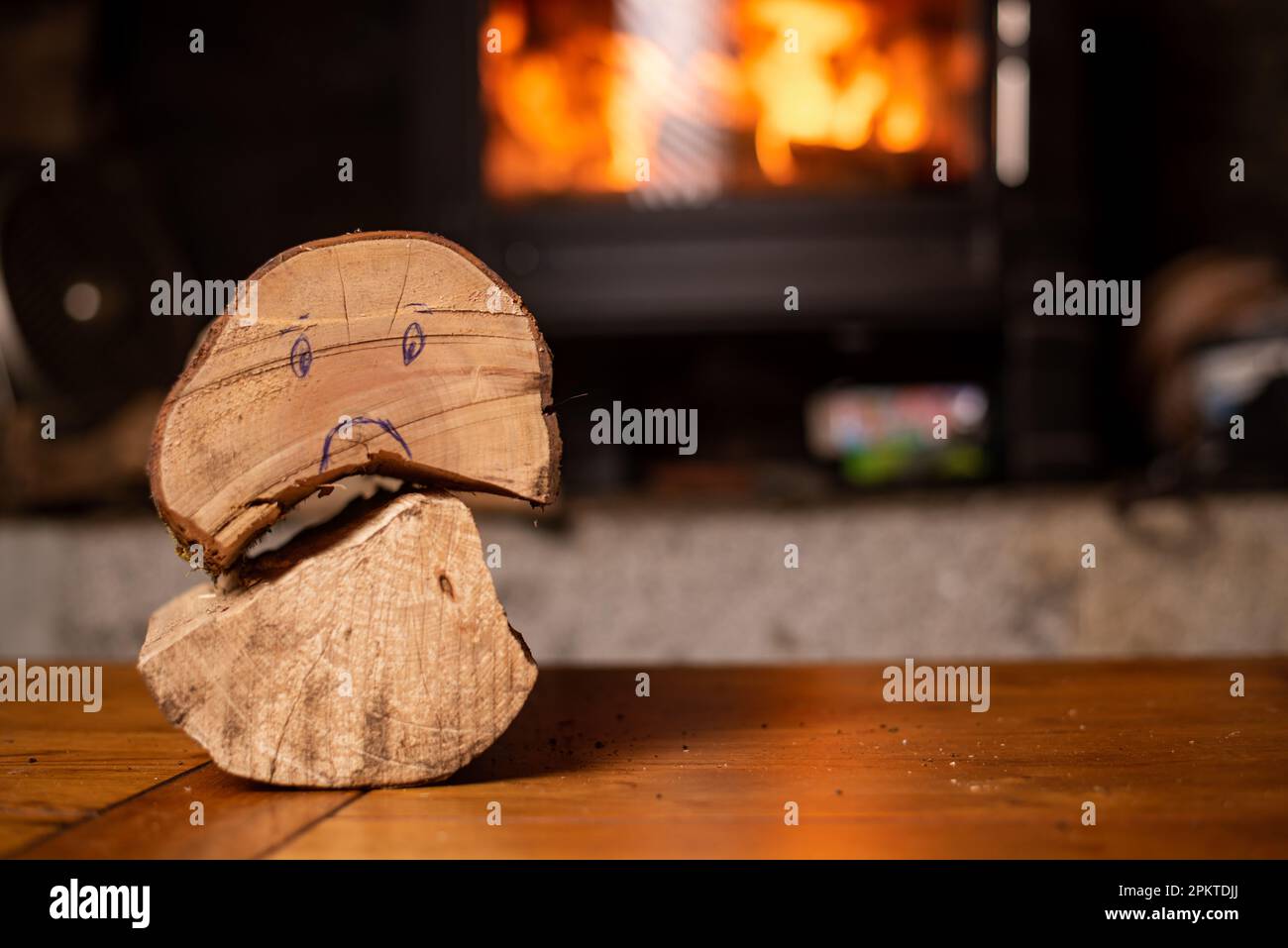 Wooden log with sad smiley. Rising price of firewood concept. Firewood ...