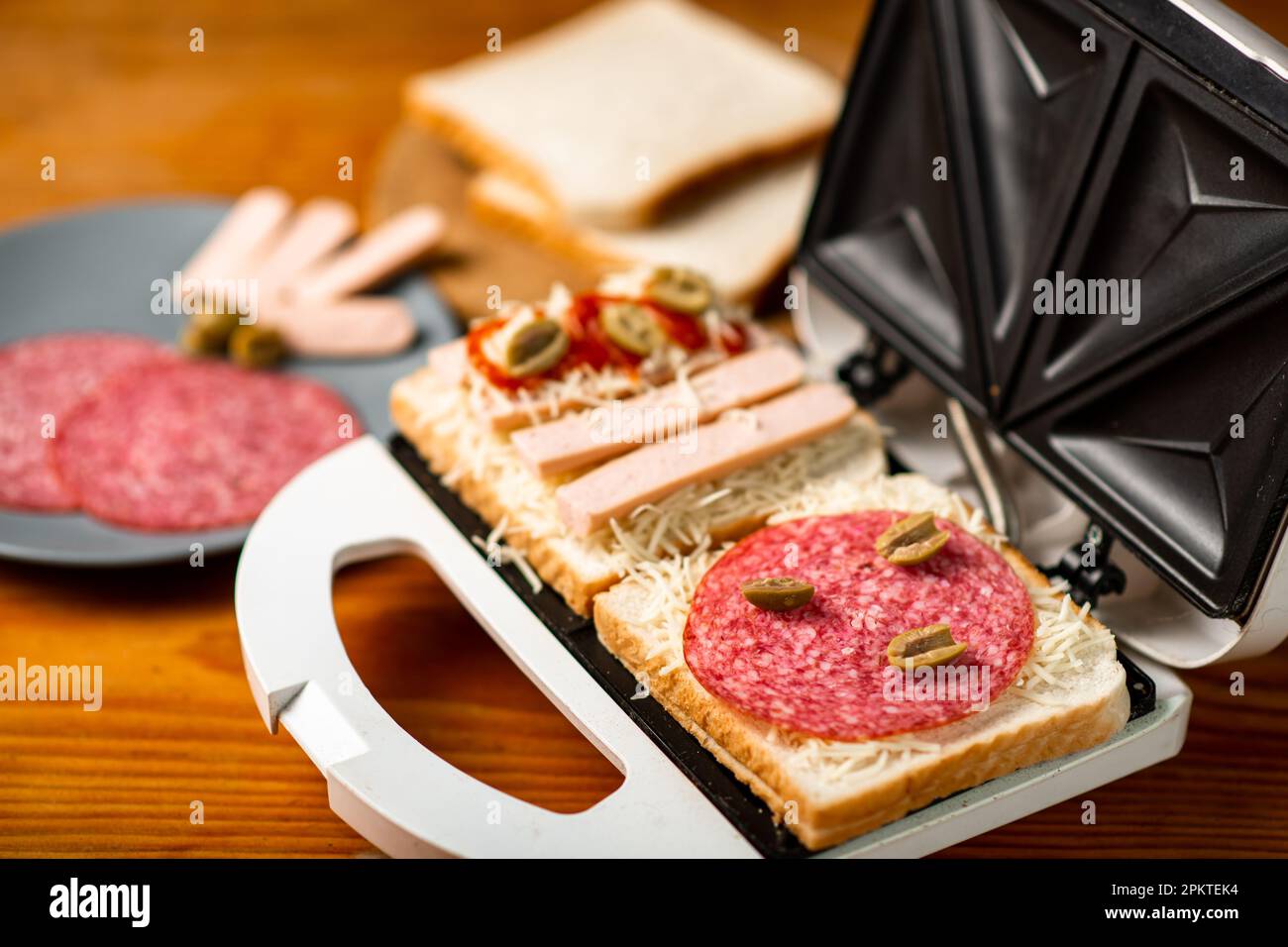 sandwich maker and cooking different sandwiches with sausage, cheese ...