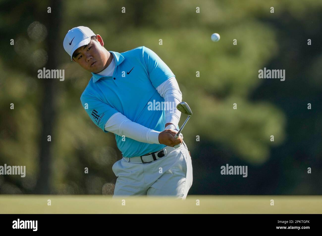 Tom Kim, of South Korea, chips to the green on the 18th hole during the ...