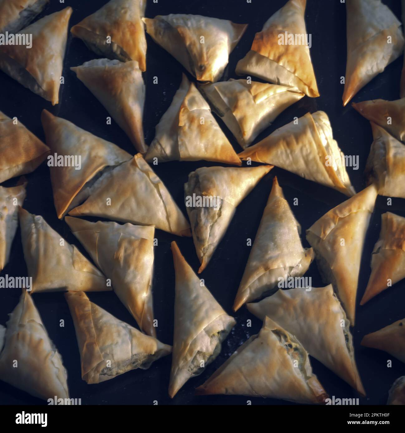 Golden brown filo triangles fresh from the oven Stock Photo - Alamy