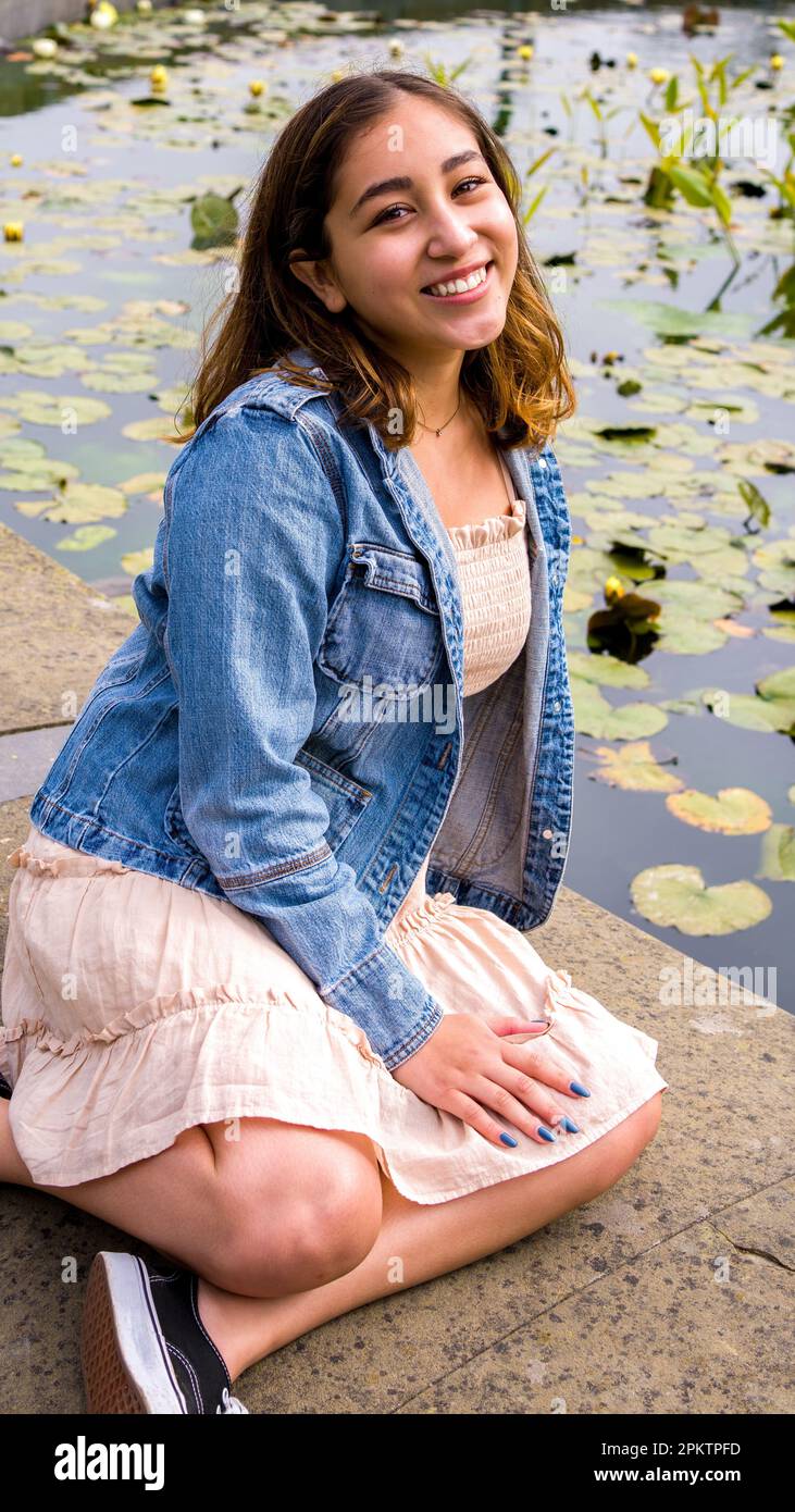 Female Asian Teen Seated Beside a Lily Pond | De Young Museum Stock ...