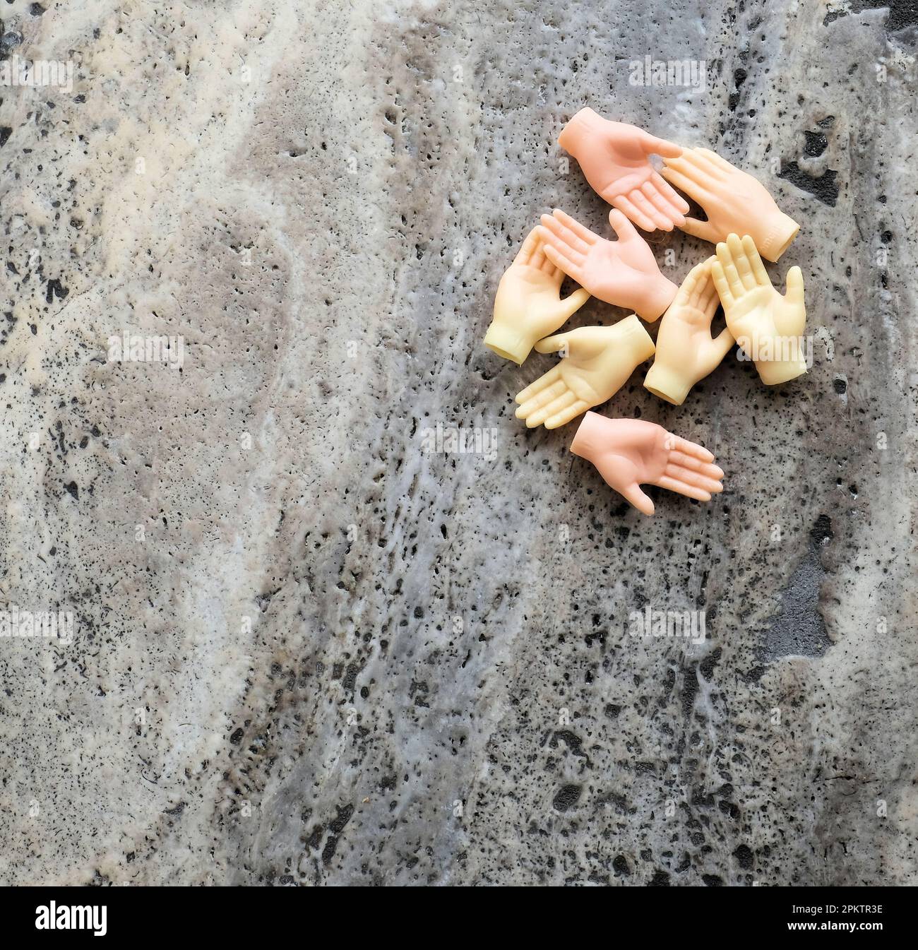 Plastic toy finger hands in different skin tones; help, assistance ...