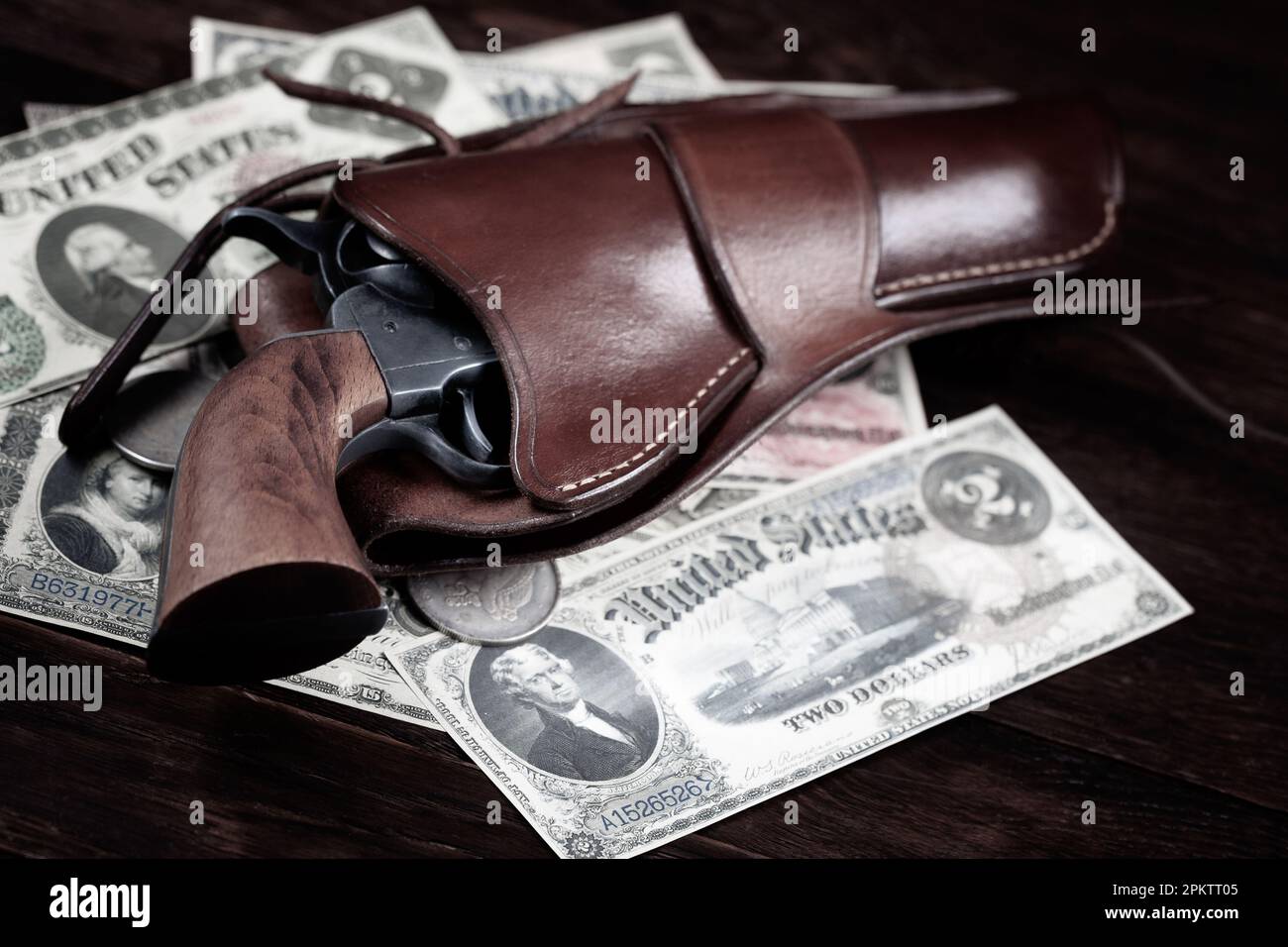 Old west Colt Peacemaker and US banknotes and silver certificates with ...
