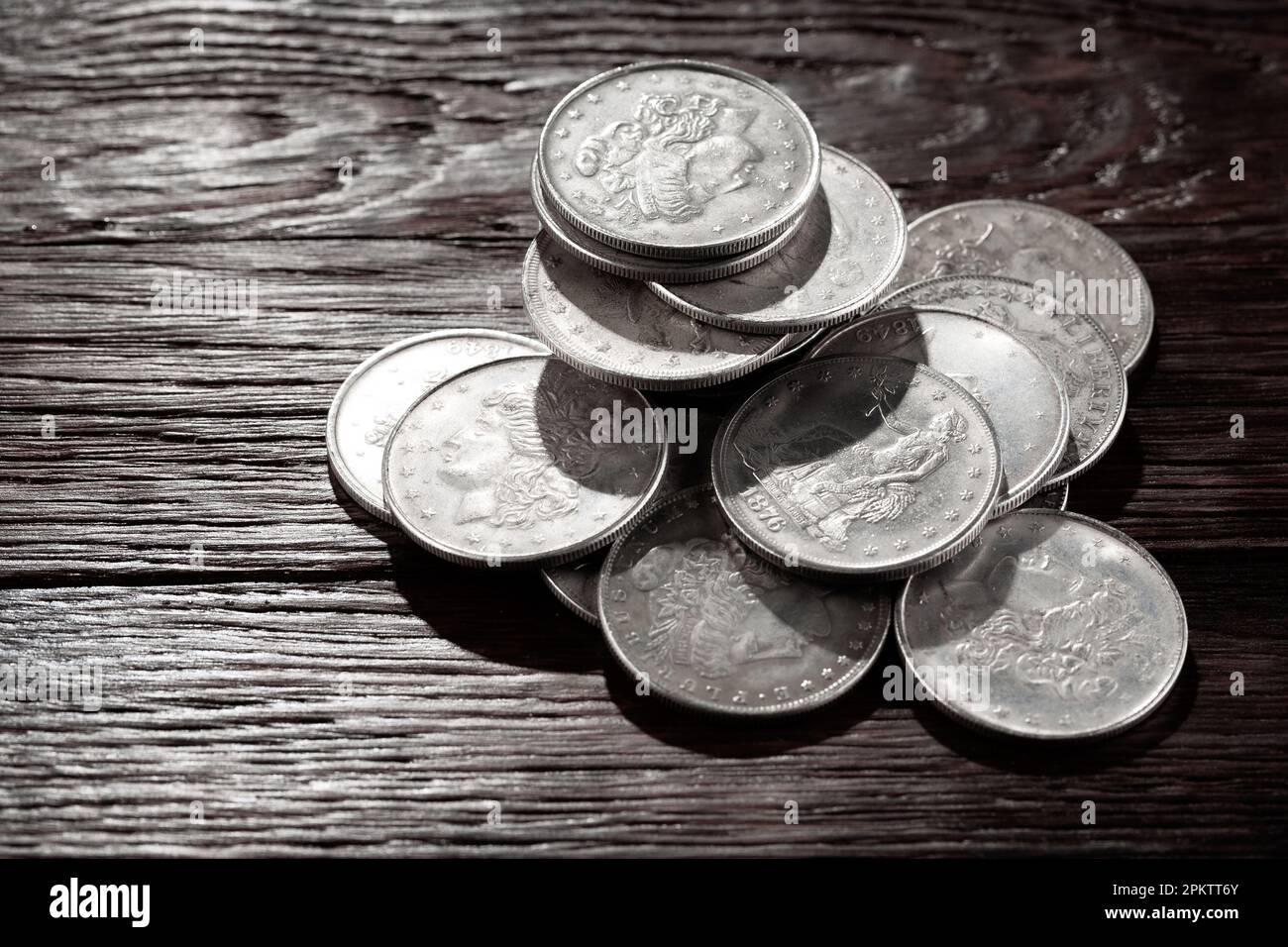 Stack of US old west dollar silver coins on wooden deck Stock Photo - Alamy