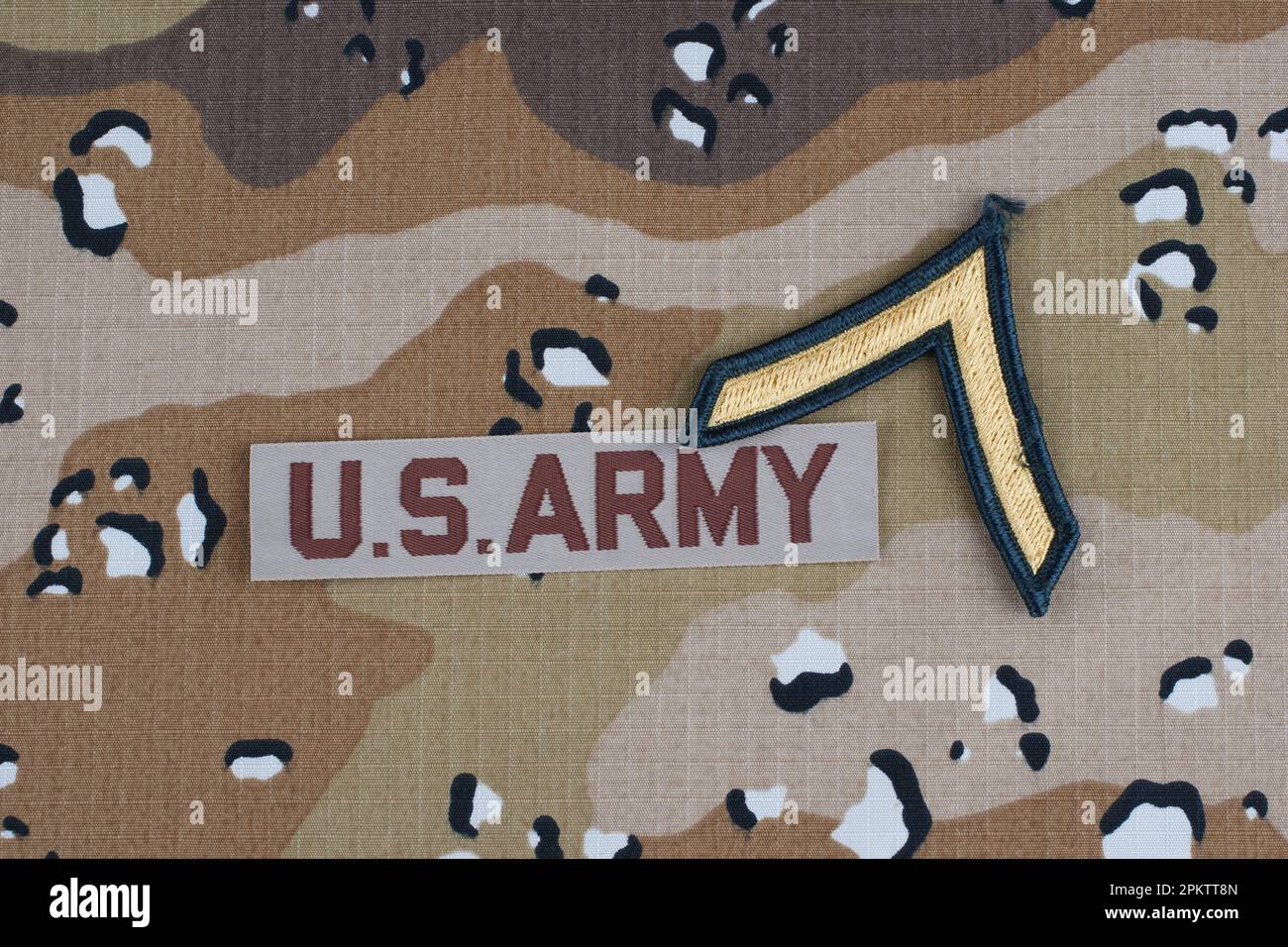 US ARMY branch tape and private rank patch on desert camouflage uniform ...