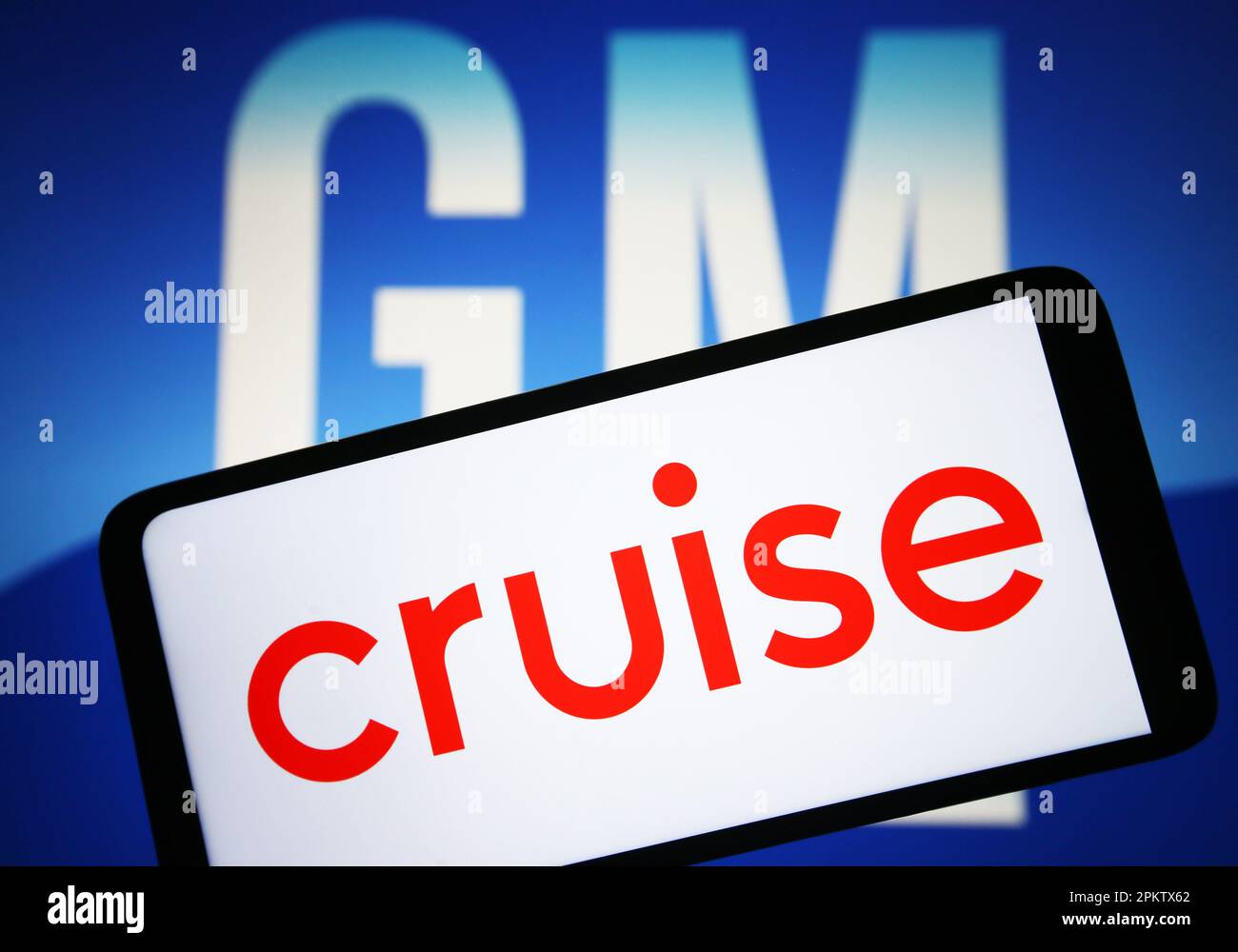 In this photo illustration, Cruise LLC logo is seen on a smartphone and General Motors Company ...