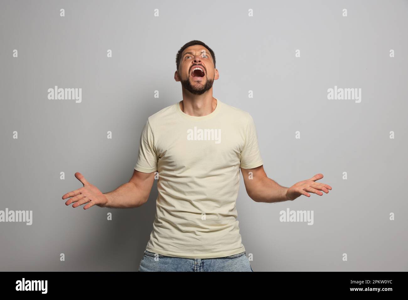 Aggressive man shouting on grey background. Hate concept Stock Photo ...