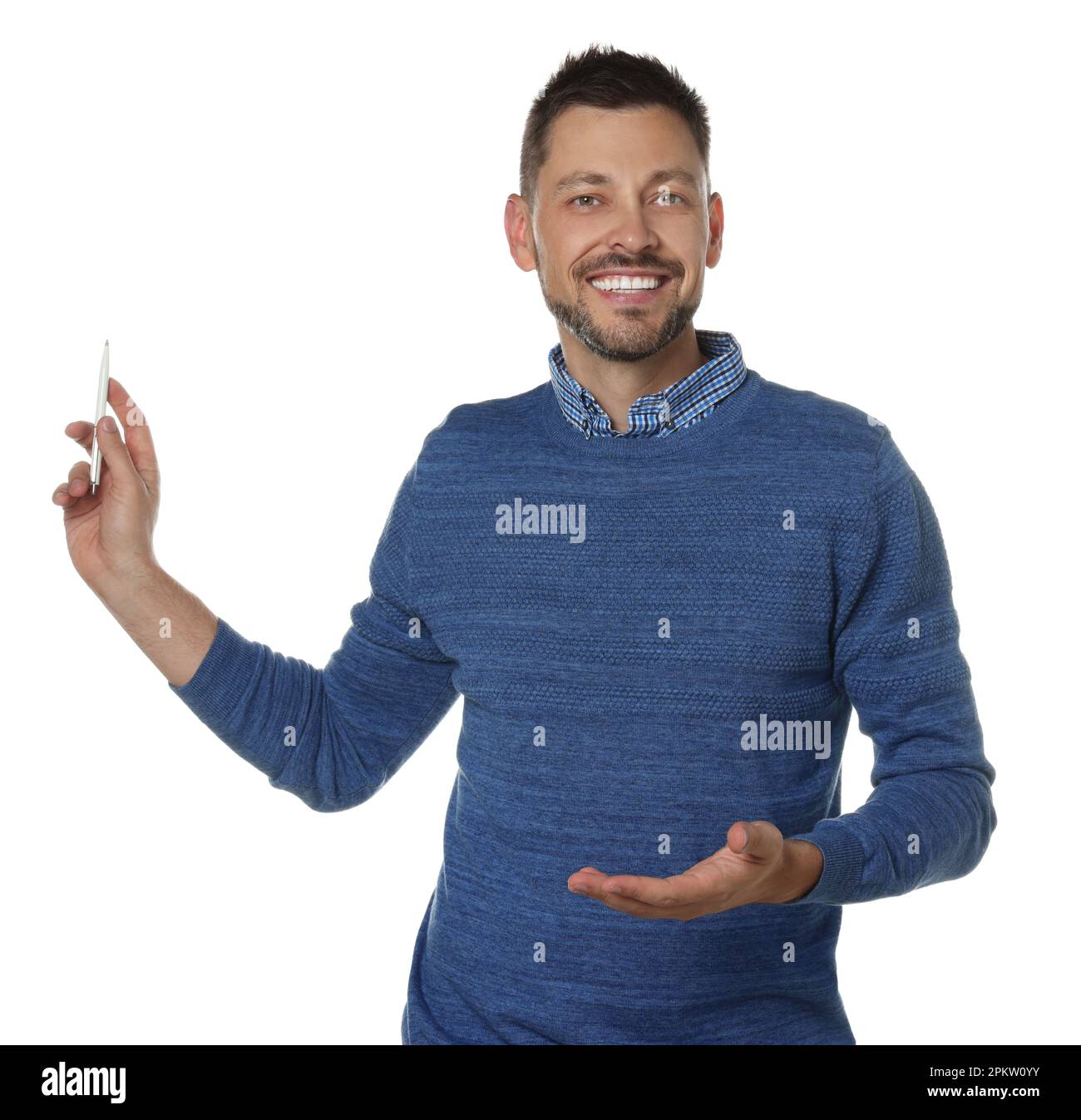 Handsome man pointing at something with pen on white background ...