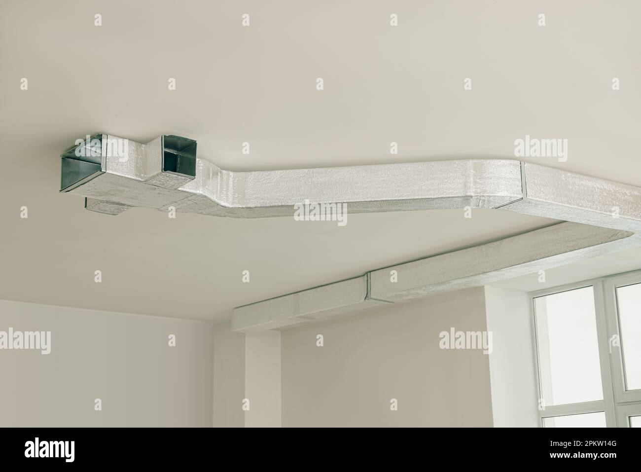 Modern pipe installed on ceiling indoors. Home renovation Stock Photo ...