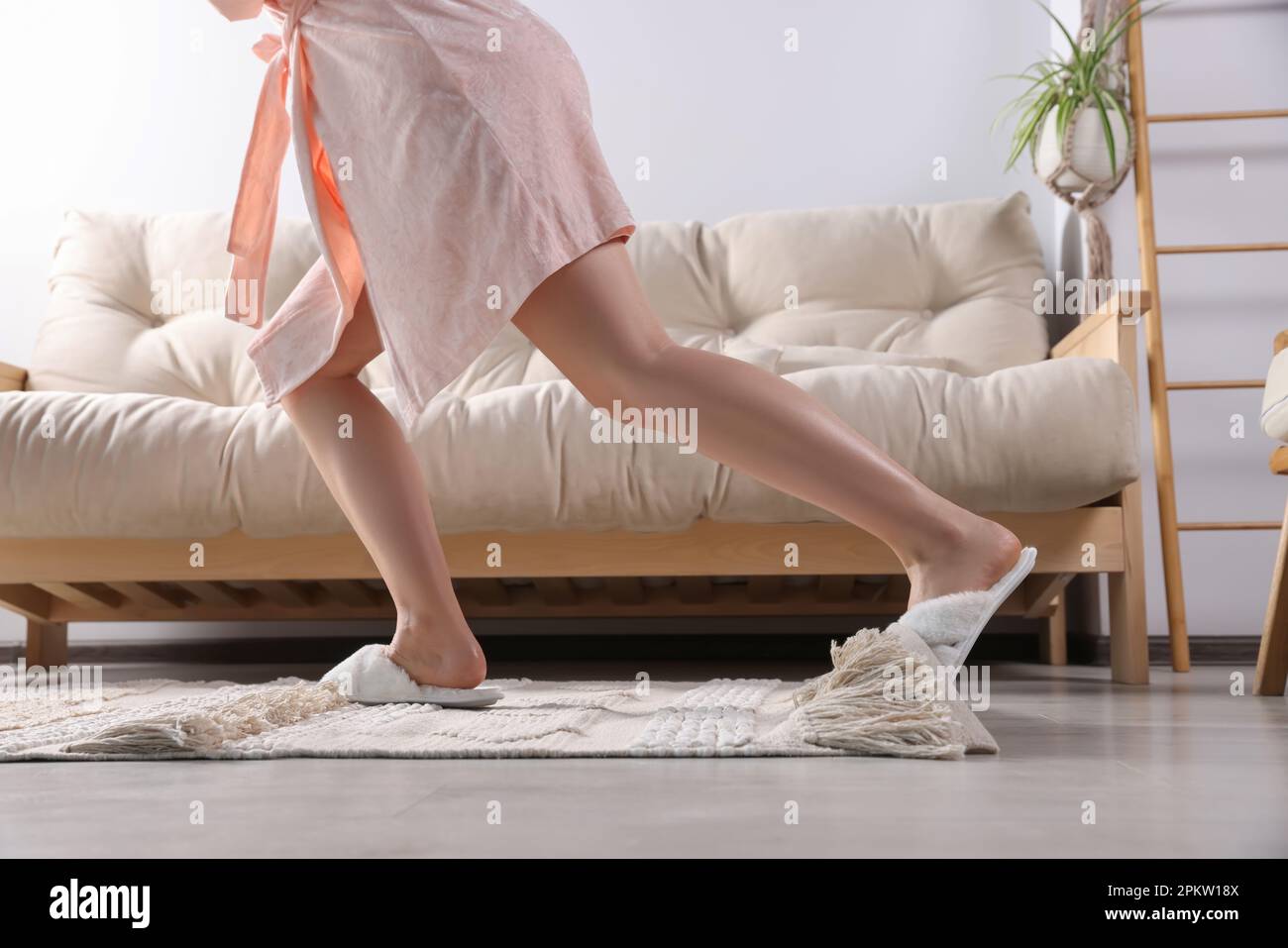 Woman tripping over rug at home, closeup Stock Photo - Alamy