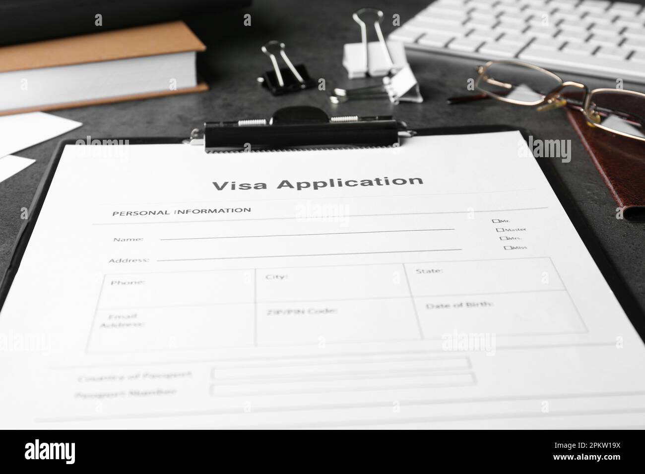 Visa application form for immigration and stationery on grey table ...
